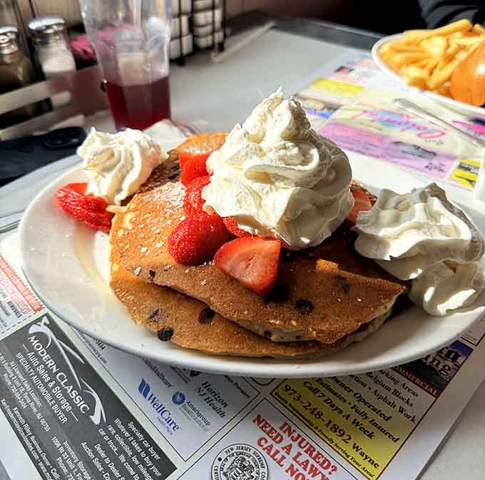 Pancakes topped with strawberries and whipped cream prove breakfast can absolutely be considered a special occasion.