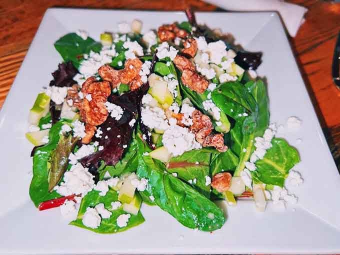 Figs, goat cheese, and candied nuts on fresh greens make salad feel less like punishment, more like reward.