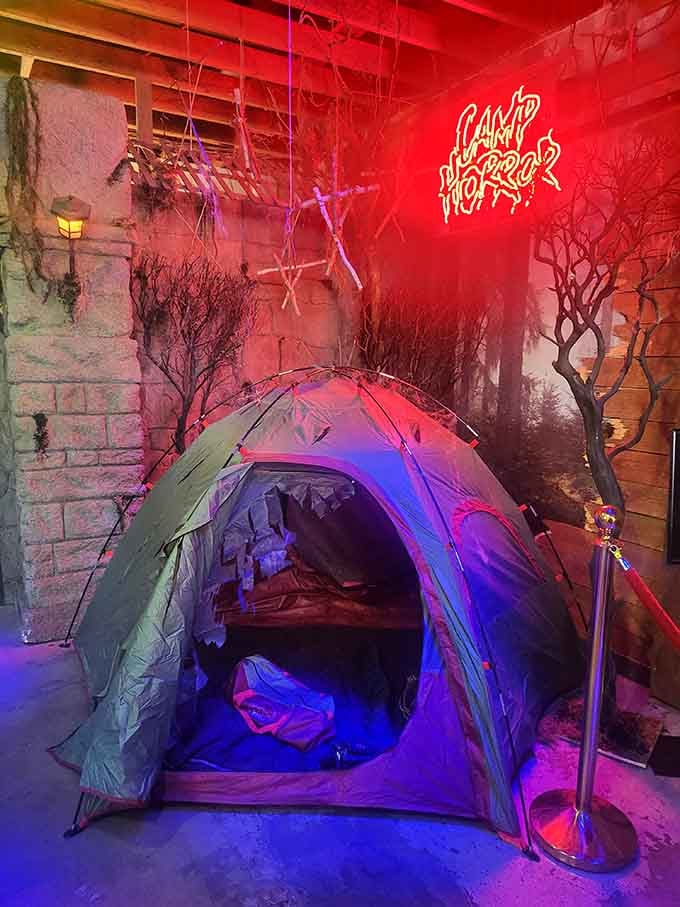 Camp Horror glows in neon red, because nothing says relaxing outdoor getaway quite like a tent in a haunted forest.