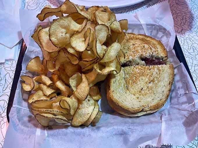 A Reuben sandwich with house-made chips that crunch louder than your teenage self sneaking in late.