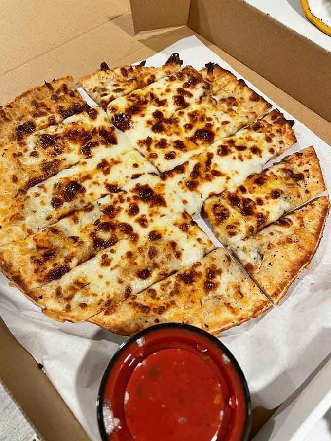 Cheesy bread pizza perfection in a takeout box, because sometimes you need comfort food at home too.