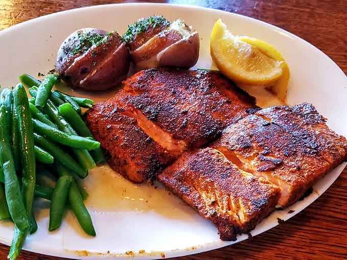 That Cajun-blackened salmon with its gorgeous spice crust looks like it swam straight from the lake into flavor paradise.