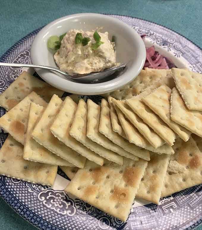 Smoked trout dip surrounded by crackers—the appetizer that'll have you fighting over the last bite.