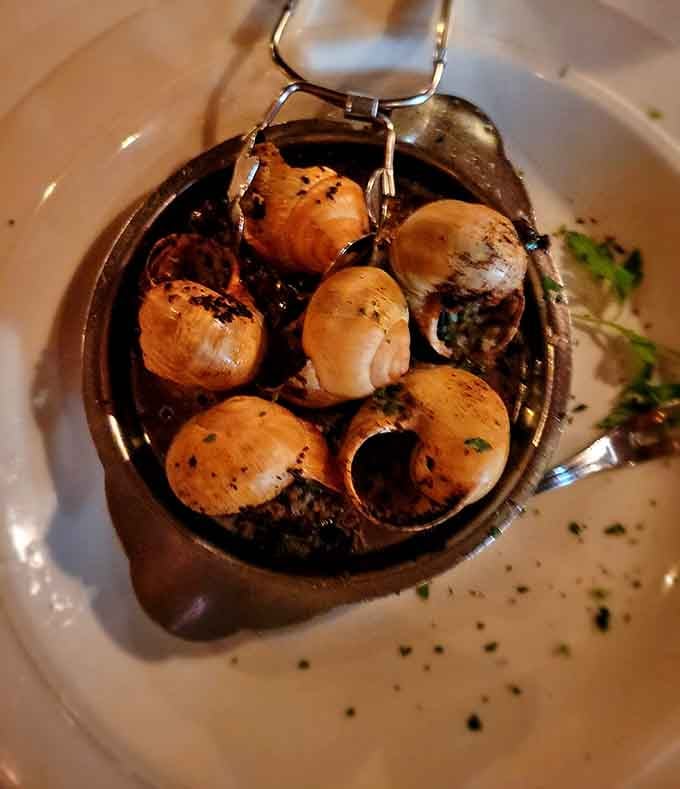 Escargots served sizzling hot remind you that adventure at dinner doesn't require a passport or subtitles.