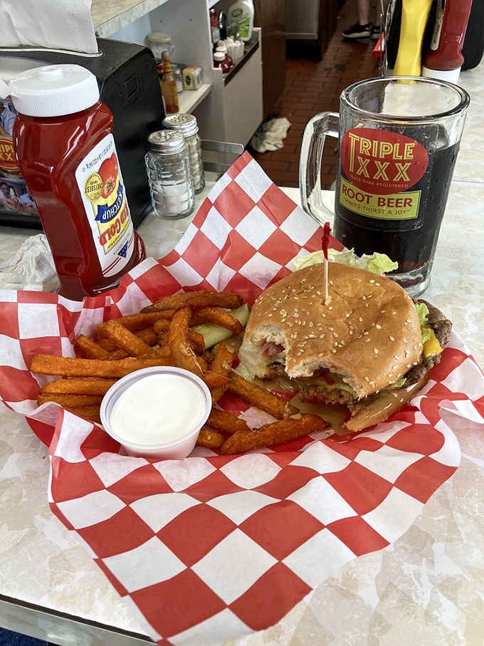 Sweet potato fries, a towering burger, and root beer in a frosted mug, the holy trinity of diner perfection.
