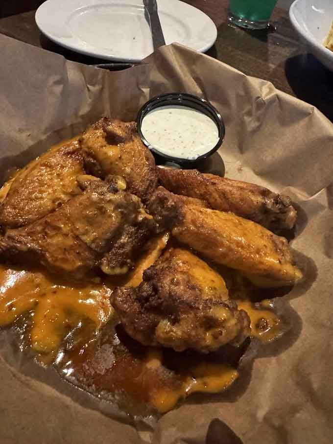 Wings glazed to glistening perfection, proving that even mythical creatures appreciate properly executed bar food classics.