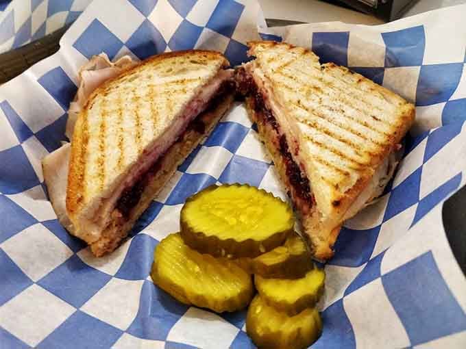 A perfectly grilled sandwich with pickles: proof that simple done right beats fancy done wrong every time.