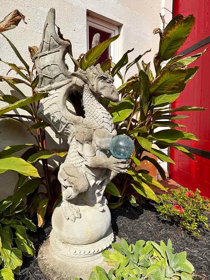 Dragon statue clutching orb reminds visitors that every proper castle needs at least one mythical creature guardian.