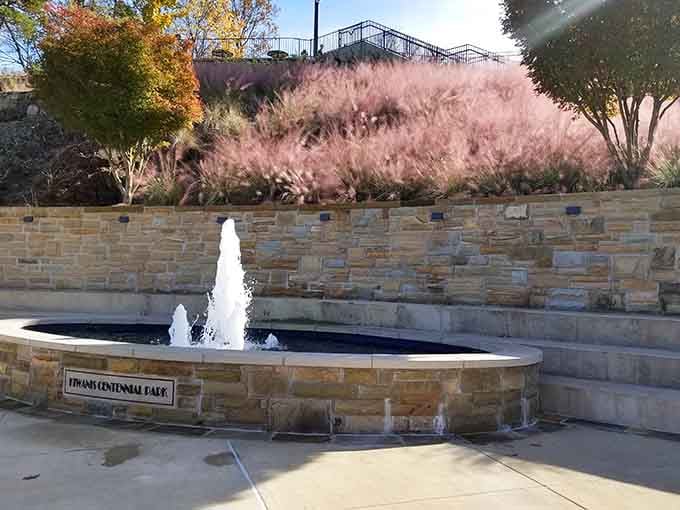 The Tricentennial Plaza fountain adds a peaceful touch to the park, because even iron gods appreciate good landscaping.