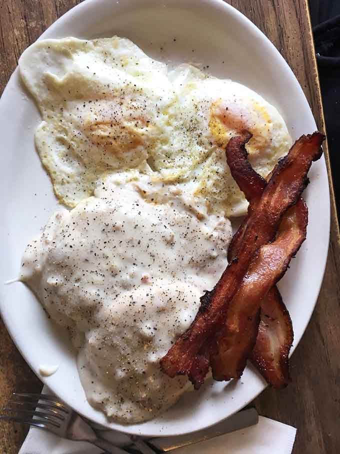 Biscuits drowning in country sausage gravy, the kind of comfort food that makes you forget your troubles entirely.