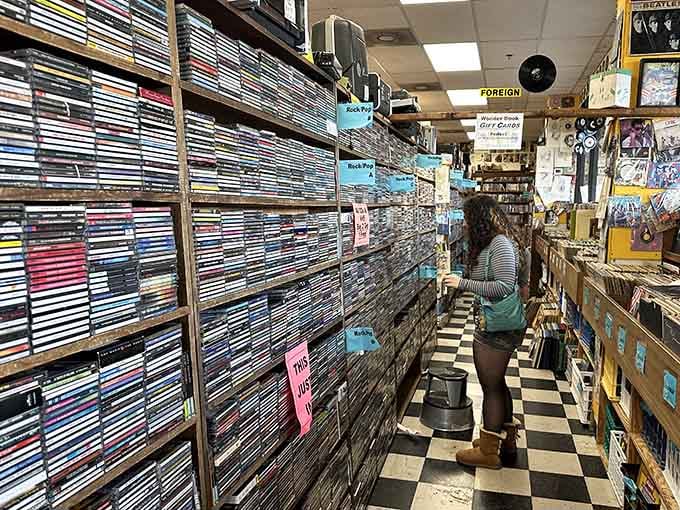 Yes, those are actual CDs and VHS tapes, proving some of us still appreciate physical media collections.