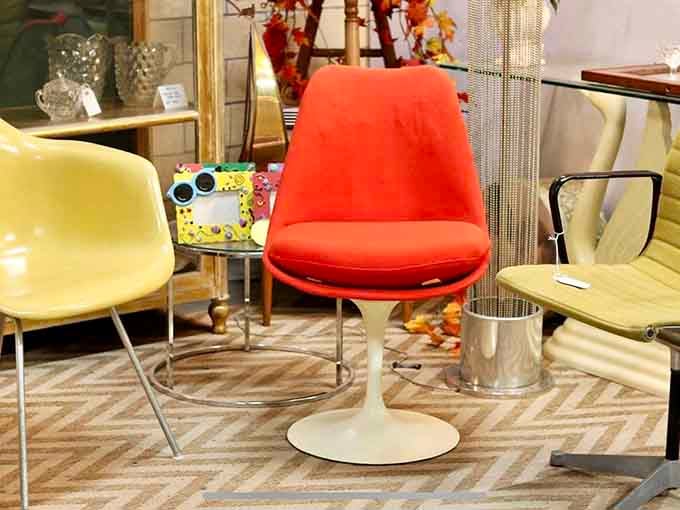 Mid-century chairs that scream "Mad Men set piece" – Don Draper would approve of that bold orange statement piece.