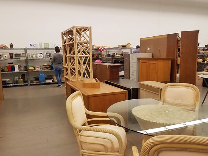 That wine rack tower stands tall like it's auditioning for a home decor magazine, surrounded by furniture with stories to tell.