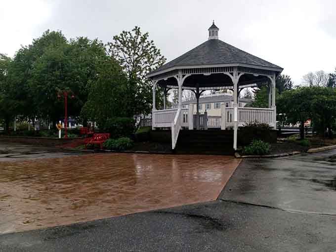 This picturesque gazebo by the pond is where shopping companions go to recover and regroup between store visits.
