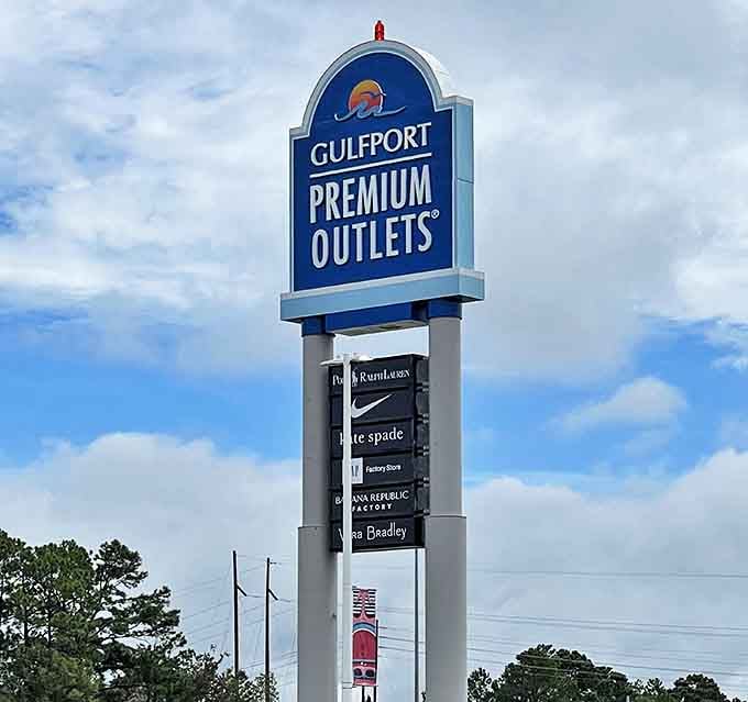 The towering sign announces your arrival at the promised land of discounts. Those brand names listed below are like a roll call of fashion's finest, all waiting at attention.