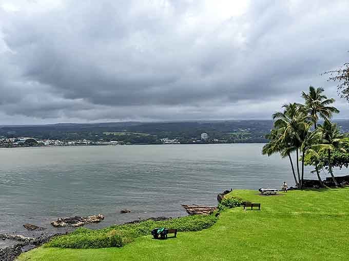 Liliuokalani Gardens provides this tranquil bayfront view, where benches invite contemplation of Hilo's ever-changing skies.