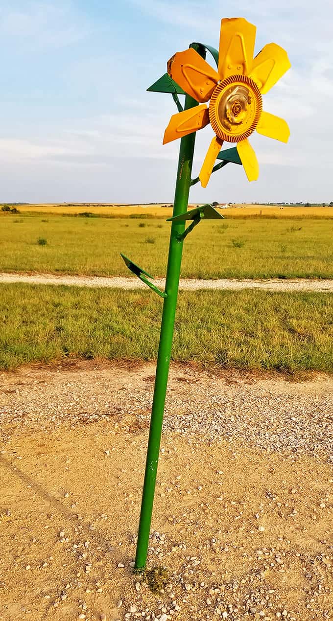 Not content with just cars, the Car Art Reserve blooms with mechanical flowers &ndash; this sunshine-yellow blossom crafted from car parts brightens even the cloudiest Nebraska day.