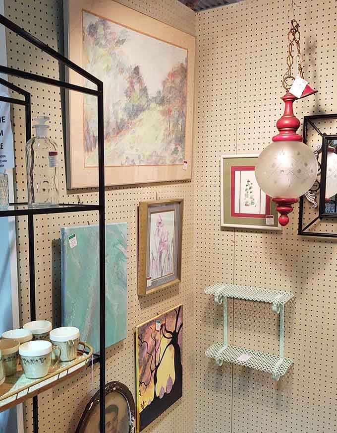 Wall art and vintage lighting create a gallery of forgotten aesthetics. That red pendant lamp is practically begging to illuminate your reading nook.