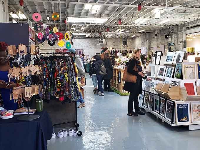 Colorful vinyl records hang from the ceiling while shoppers explore jewelry, art, and handcrafted treasures below.