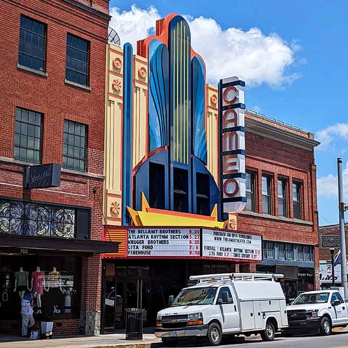 Art Deco theater marquee blazes with color and promise, bringing entertainment to town without requiring a second mortgage to attend.