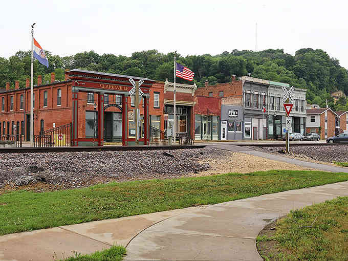 Railroad tracks run right through downtown where brick buildings wear their age like badges of honor and authentic character.