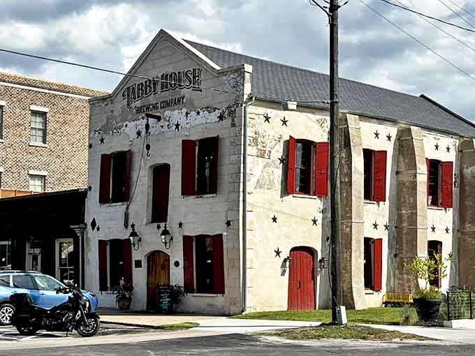 Darien's Tabby House Brewing Company occupies a whitewashed historic building with striking red shutters. Its star-studded exterior promises stellar craft brews inside.