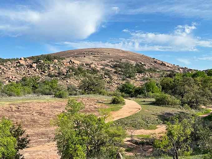 The smooth granite dome beckons hikers upward along trails worn smooth by generations of adventurous souls.
