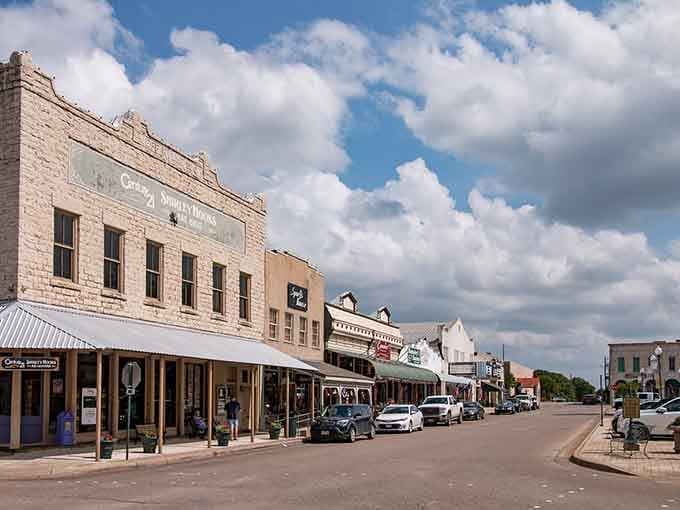 Wide main street lined with beautifully preserved buildings, each facade telling tales of frontier days and cowboy heritage.