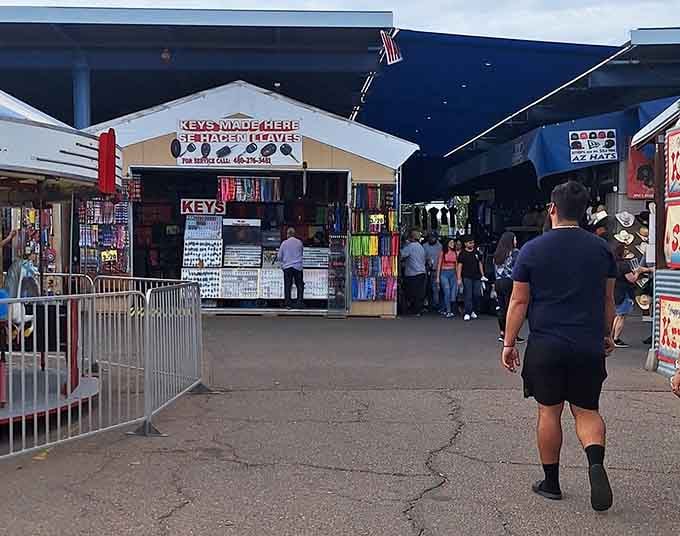 The key-making booth stands ready while shoppers explore endless rows of vendors in this sprawling marketplace.