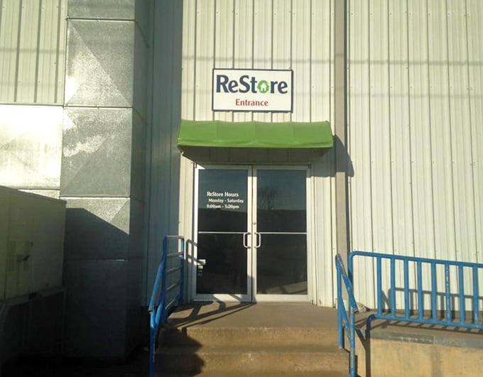 The simple green awning marks the entrance to a world of recycled building materials.