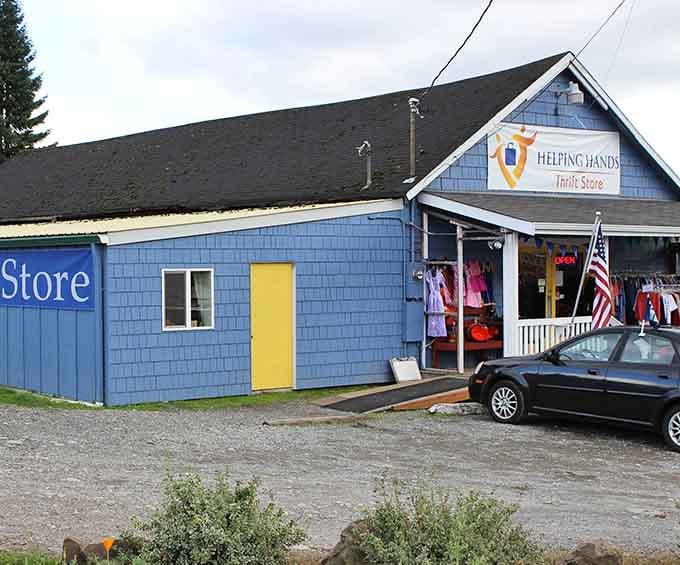 That cheerful blue building with bright yellow door radiates small-town charm and community spirit in every shingle.
