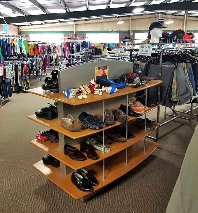 Warehouse-style shelving holds shoes and accessories in a space that feels more organized than chaotic.