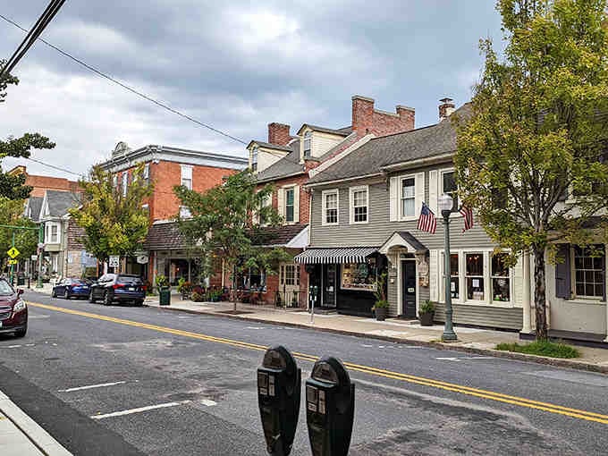 Striped awnings and historic facades create a streetscape that feels both timeless and wonderfully welcoming to wandering visitors.