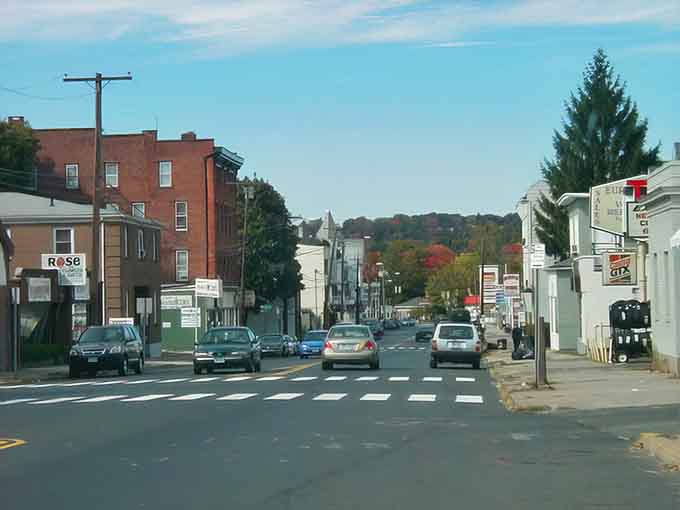 Autumn colors frame this residential street where church steeples rise above everyday life, peaceful and authentically New England through and through.