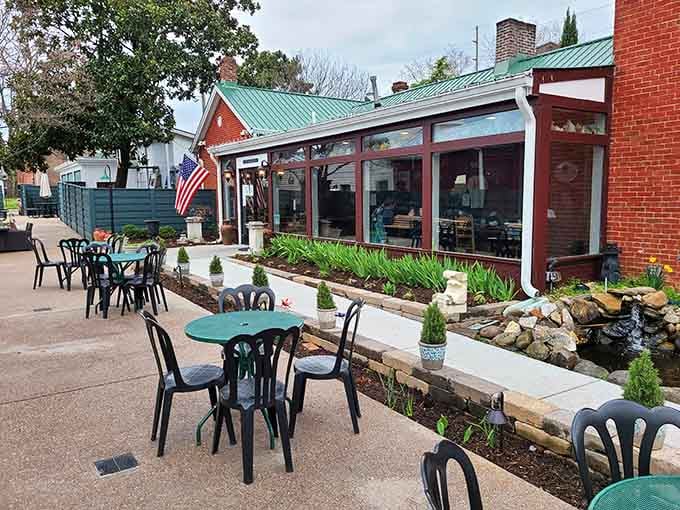 Monell's garden patio feels like stepping into a secret Southern oasis. Those green tables promise relaxation before the feast begins.