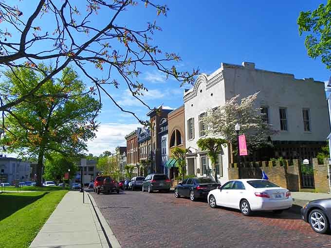 Springtime blooms frame Mount Sterling's downtown where brick sidewalks and parked cars suggest a thriving, walkable business district.
