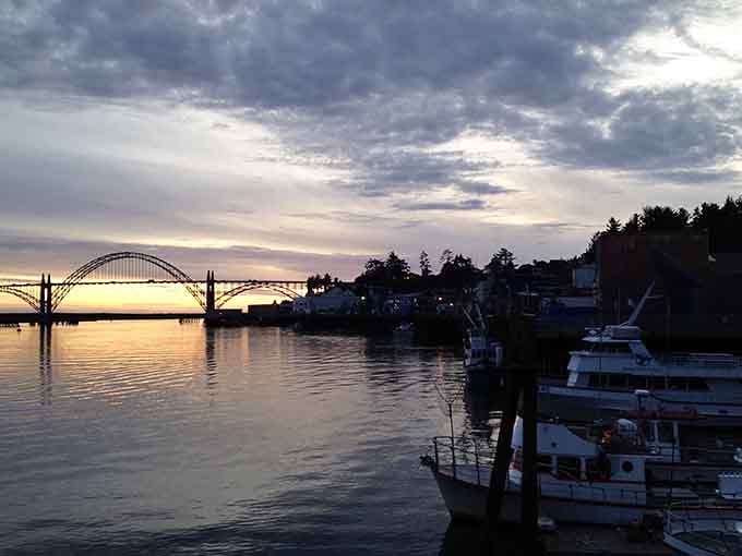 Newport's iconic bridge frames a sunset that turns the harbor into liquid gold, proving some views simply can't be improved upon.