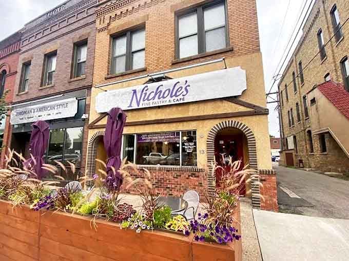 Purple flowers spilling from planters add European charm to this corner bakery and caf&eacute;'s welcoming entrance.