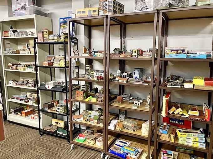 Rows of miniature buildings fill the shelves, representing countless hours of detailed craftsmanship in this model-maker's paradise.