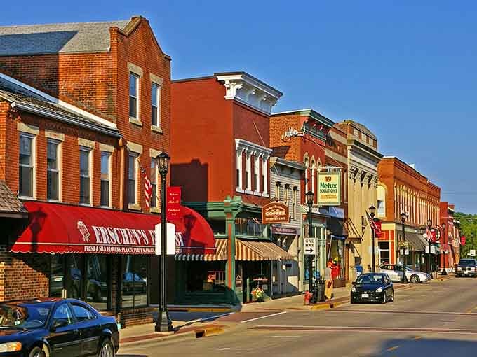 Colorful awnings and vintage storefronts create a streetscape that feels like stepping into a friendlier, simpler era.