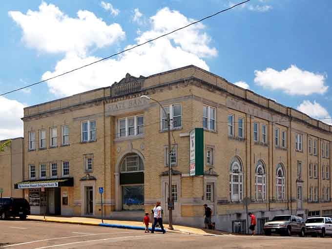 Classical columns frame grand arched windows on this historic building, showing that small towns once built things to last forever.