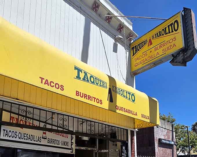 El Farolito's sunshine-yellow awning stands out like a delicious warning sign: "Prepare for burrito bliss ahead!"