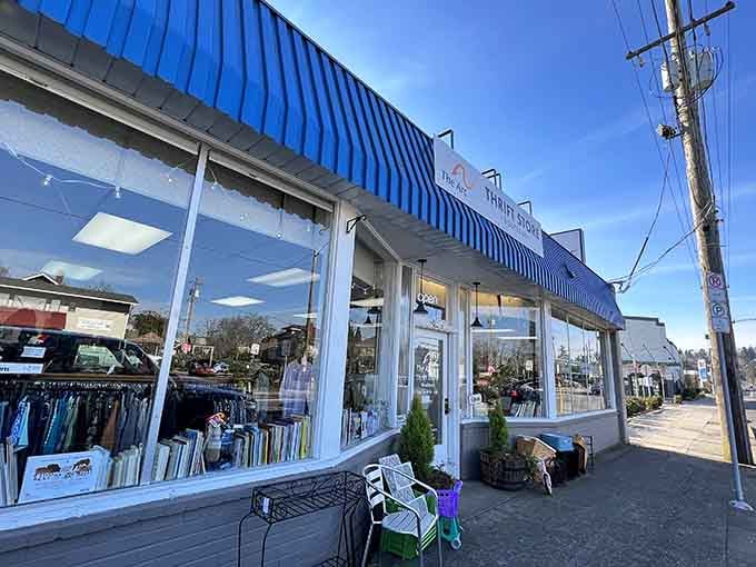 The bright blue awning and large windows create a boutique atmosphere that elevates the thrift shopping experience.
