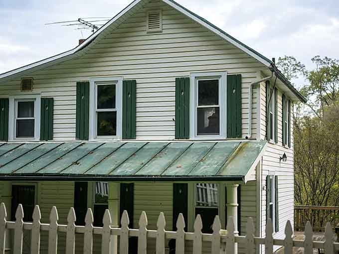 The white picket fence and green shutters give this farmhouse an innocent appearance that belies its notorious history.