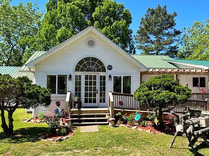 That arched doorway and white siding give off serious cottage vibes—breakfast in a storybook, basically.