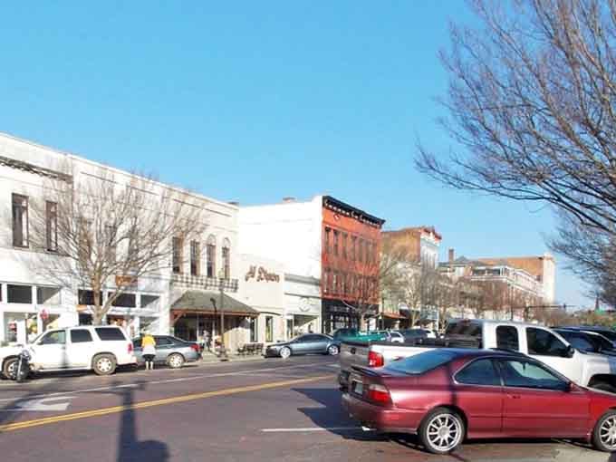 Winter trees frame this bustling main street where locals still park downtown and actually know their neighbors' names.