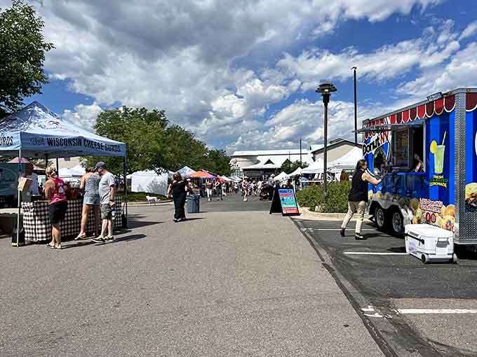 Vendors line the walkway as dramatic clouds roll overhead, making every shopping trip feel like an event.