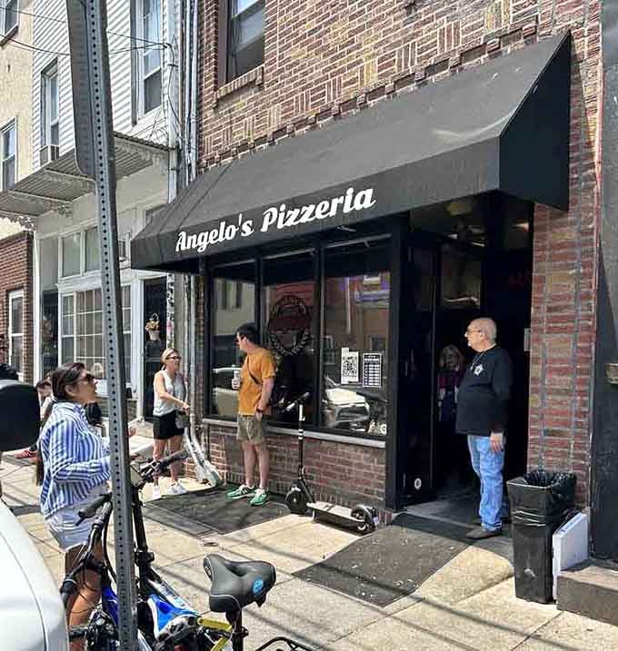 That simple black awning conceals Philadelphia's worst-kept secret—pizza that makes even New Yorkers question their loyalty.