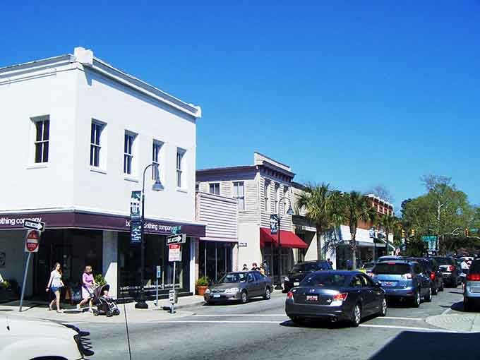 Families strolling past historic buildings and palm-shaded sidewalks capture the essence of coastal Carolina living at its finest.