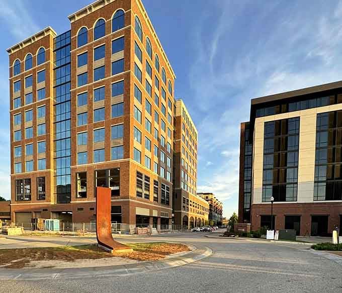 Brick facades catching golden light create urban beauty that doesn't charge admission or require a second mortgage.